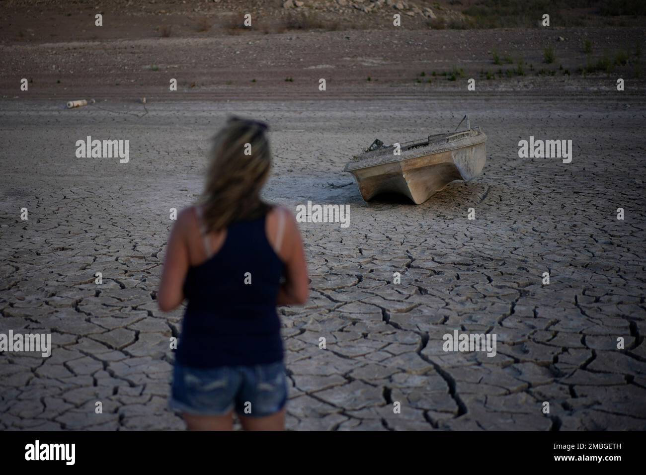 Misha McBride looks at a formerly sunken boat now on cracked earth ...
