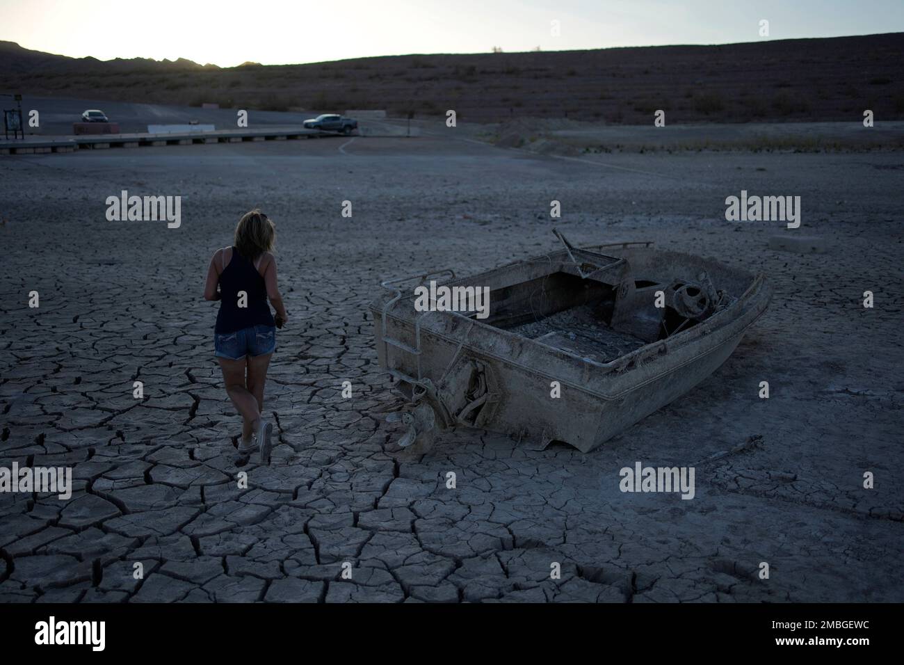 Misha McBride looks at a formerly sunken boat now on cracked earth ...