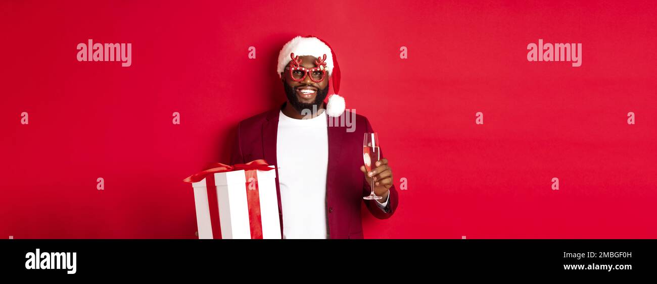 Christmas. Handsome african american man in party glasses and santa hat ...