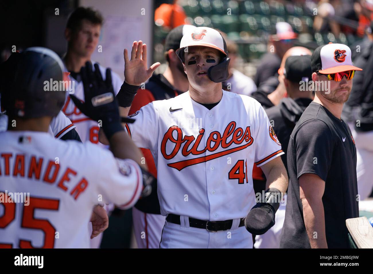 Baltimore Orioles' Tyler Nevin, center, is greeted in the dugout after ...