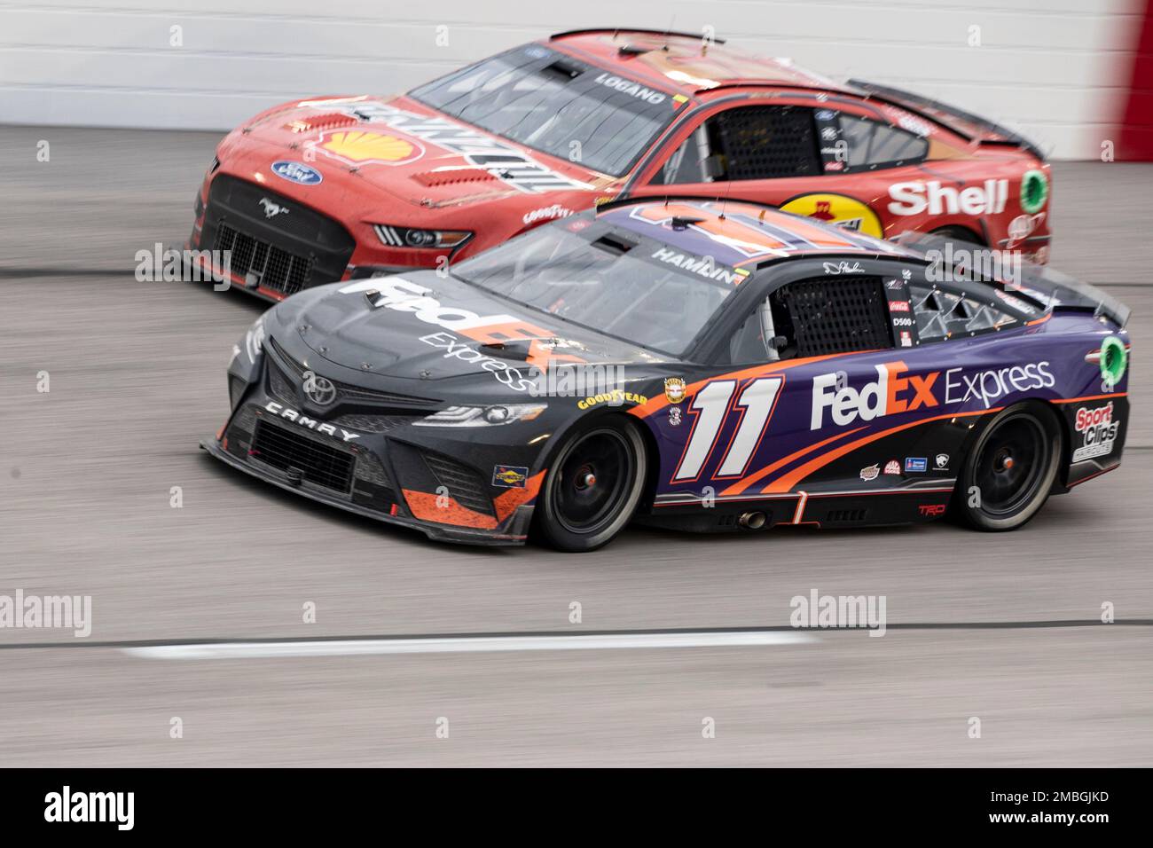 Denny Hamlin (11) passes Joey Logano (22) during a NASCAR Cup Series ...