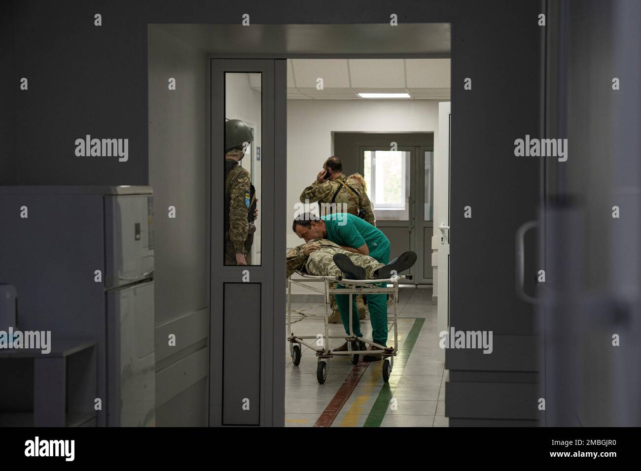 A doctor treats a Ukrainian serviceman injured inside the hospital ...