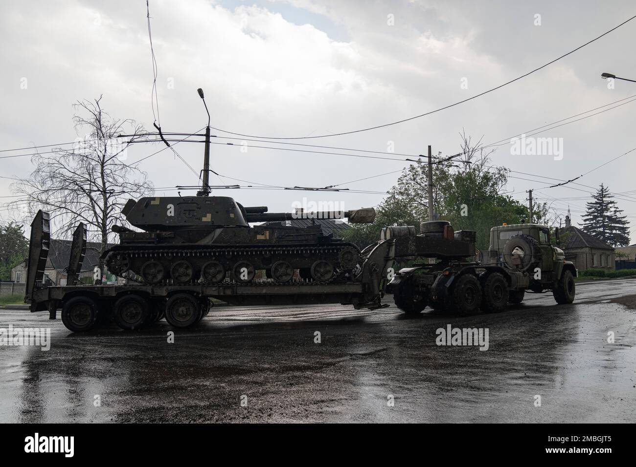 A military truck transports a platform with an Ukrainian self-propelled ...