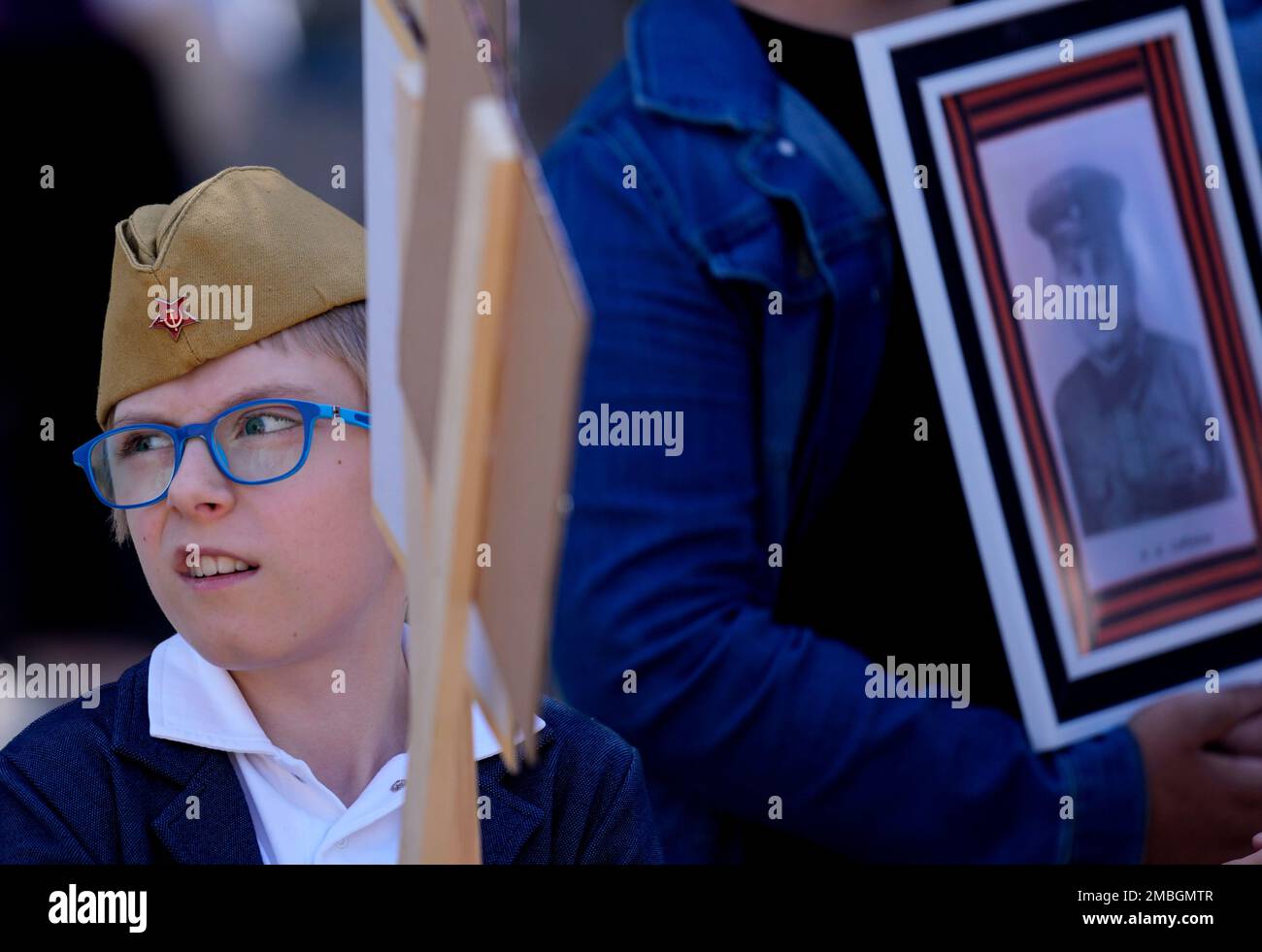 A boy wearing a World War II guerrilla cap with the five-point star ...