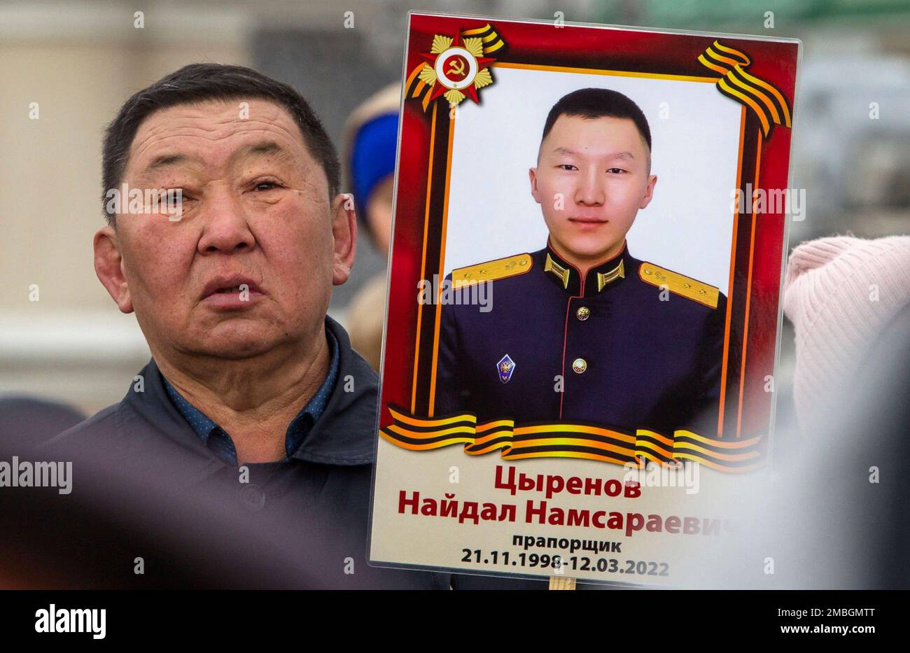 A man holds portrait of Russian Army officer Naidal Tsyrenov, who was ...