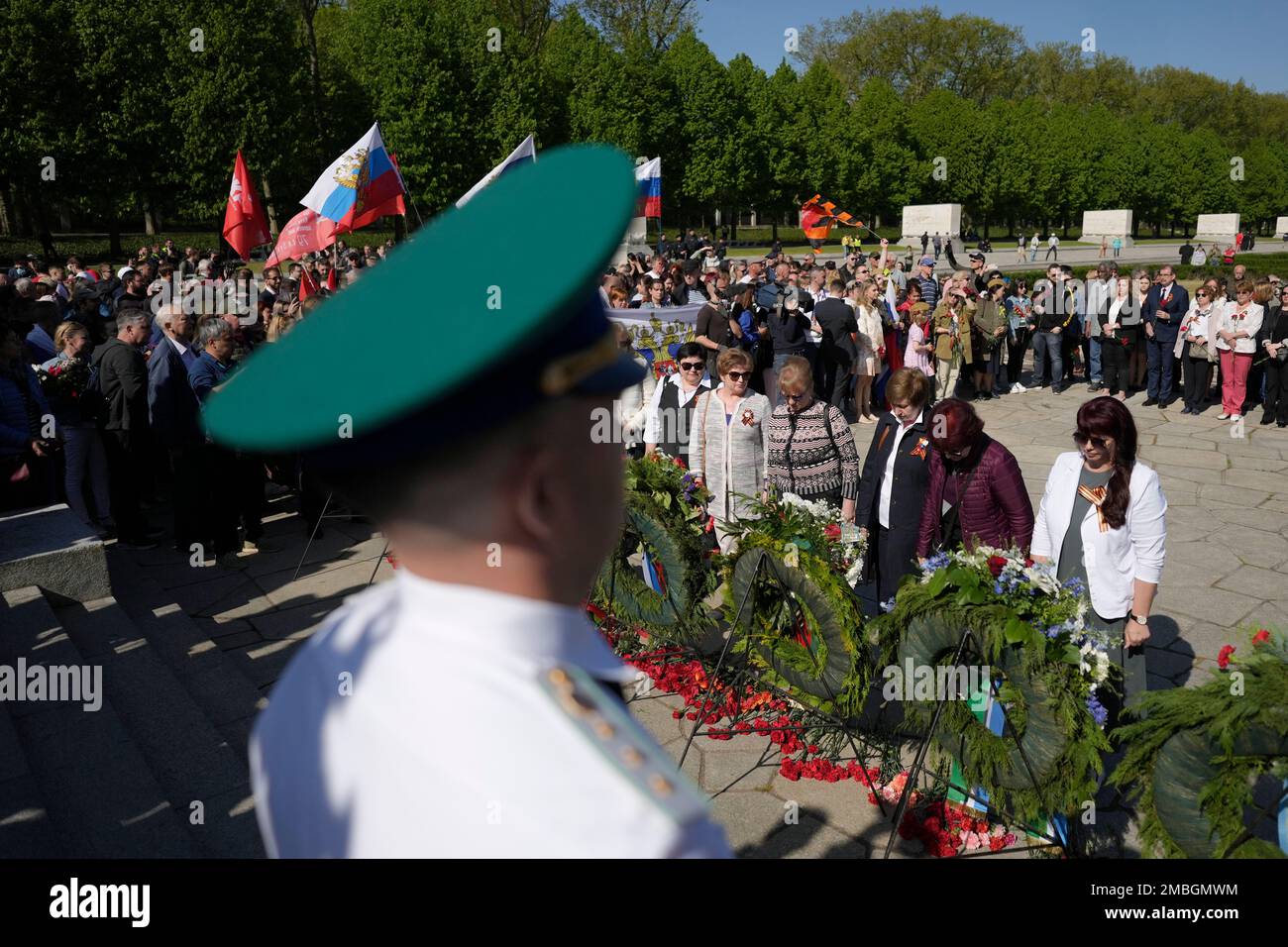 People attend a wreath laying ceremony to commemorate the end of World ...