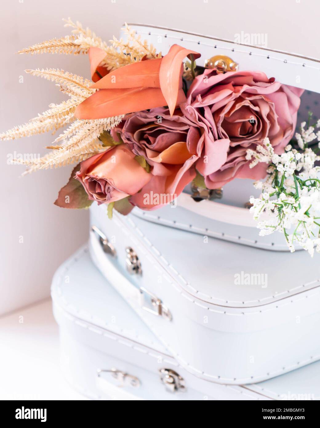 A vertical shot of a bouquet of flowers in muted red shades inside a ...