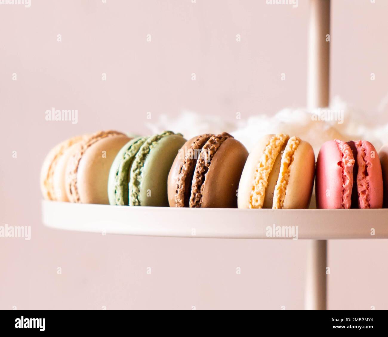 A closeup shot of colorful macarons on a round display tray Stock Photo ...