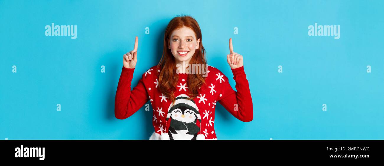 Winter holidays and celebration concept. Cute redhead girl in Christmas ...