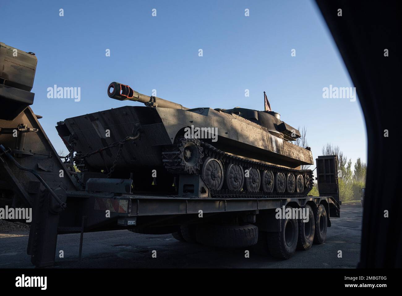 A military truck transports a platform with Ukrainian self-propelled ...