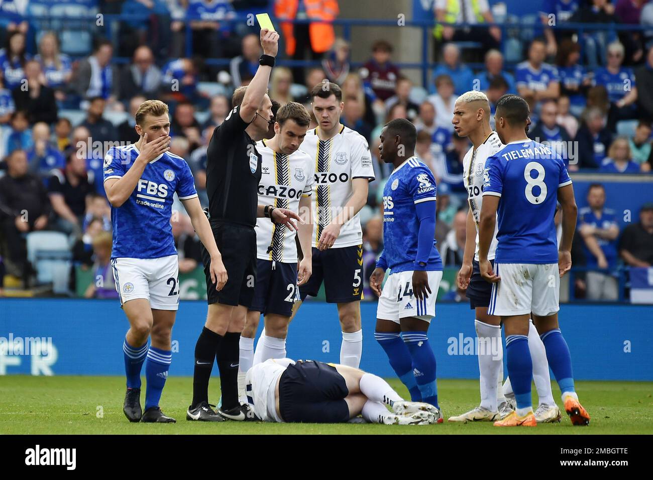 Referee Craig Pawson gives a yellow card to Leicester's Nampalys Mendy, third right, during the ...