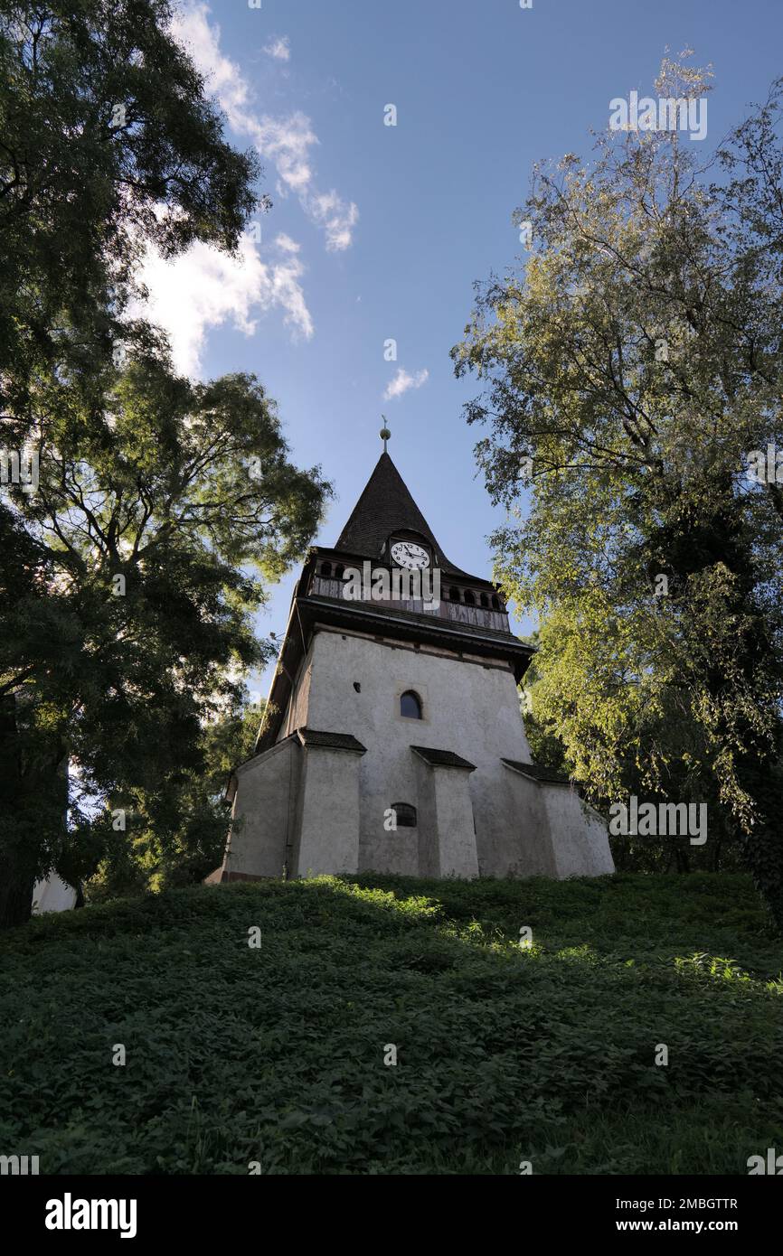A low-angle shot of a Gothic Protestant Church of Avas, tucked among ...