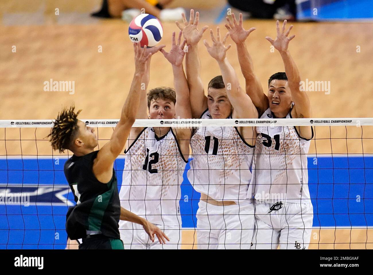 Hawaii outside hitter Chaz Galloway, left, hits over Long Beach State ...