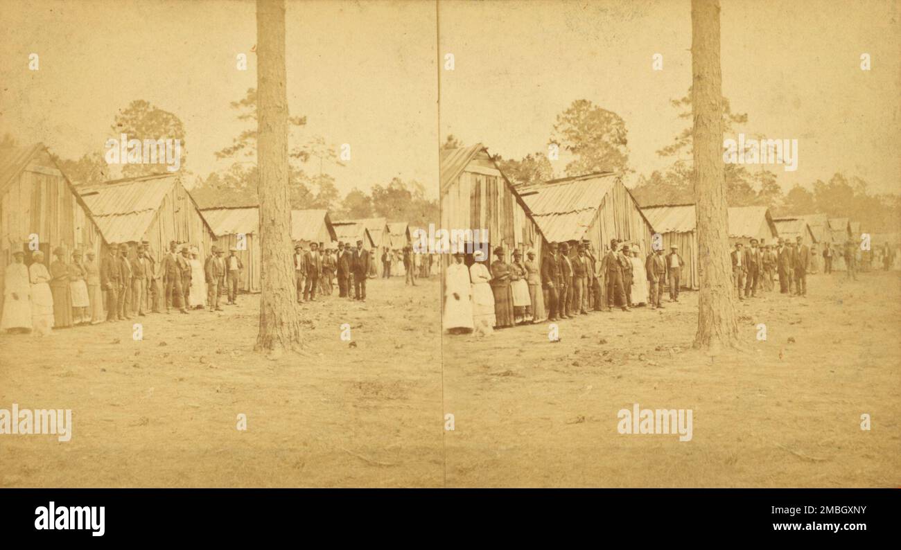 Group lined up in front of a row of shacks, (1868-1900 Stock Photo - Alamy