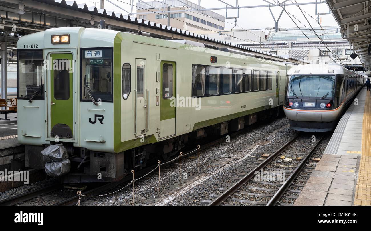 JR East KiHa 111 Series and JR Central 383 Series Shinano express trains at Nagano Station in ...