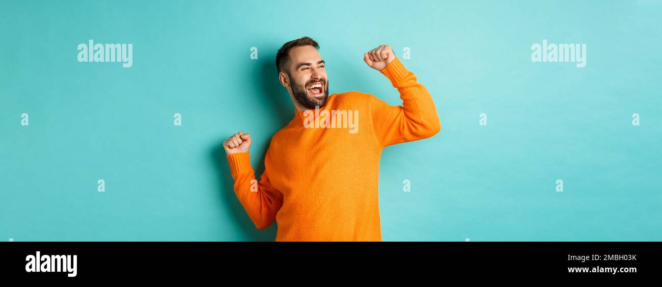 Happy man raising arm, feeling like winner, triumphing and celebrating ...