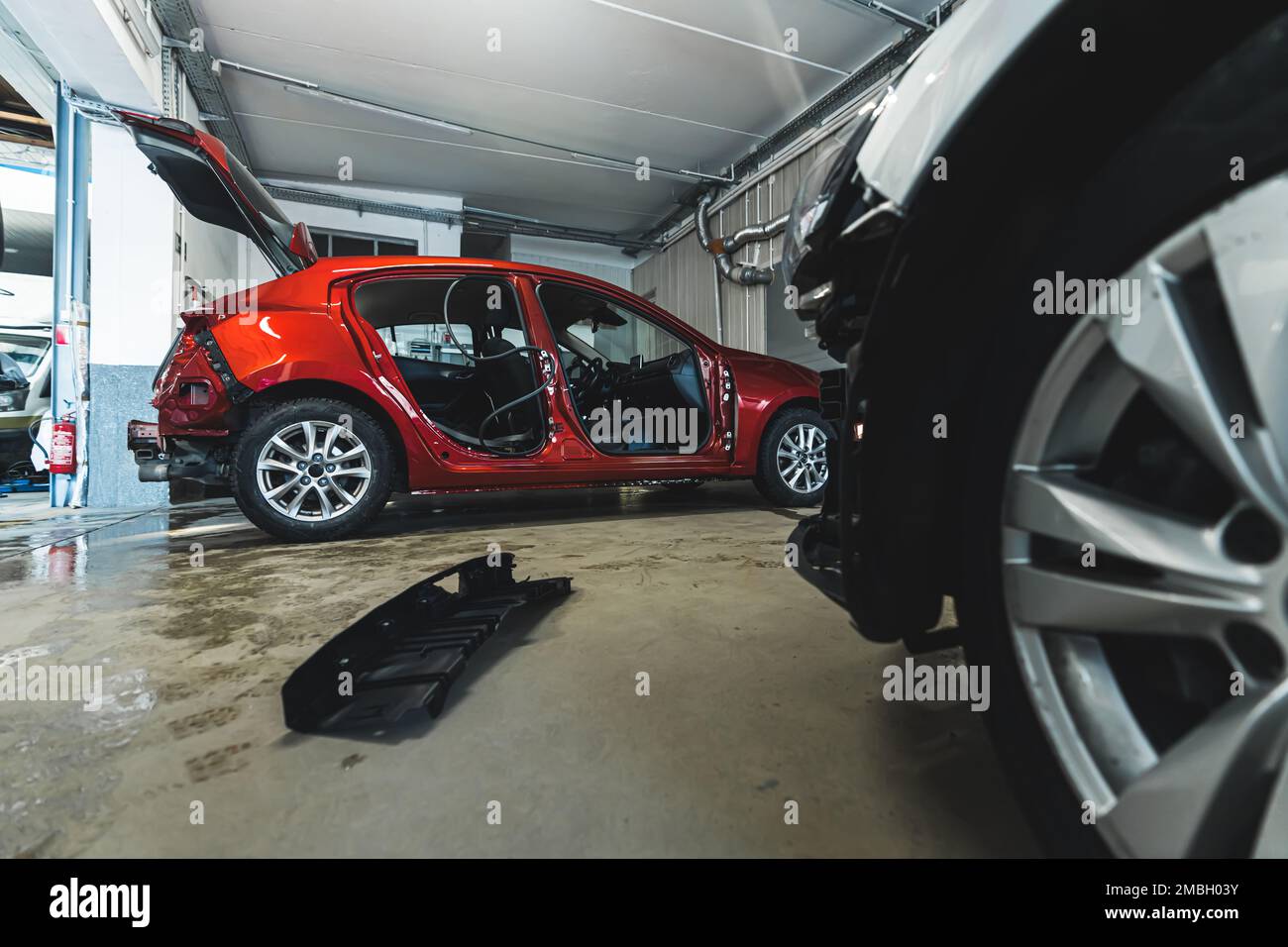 Red car body at repair shop, indoor background shot. High quality photo ...