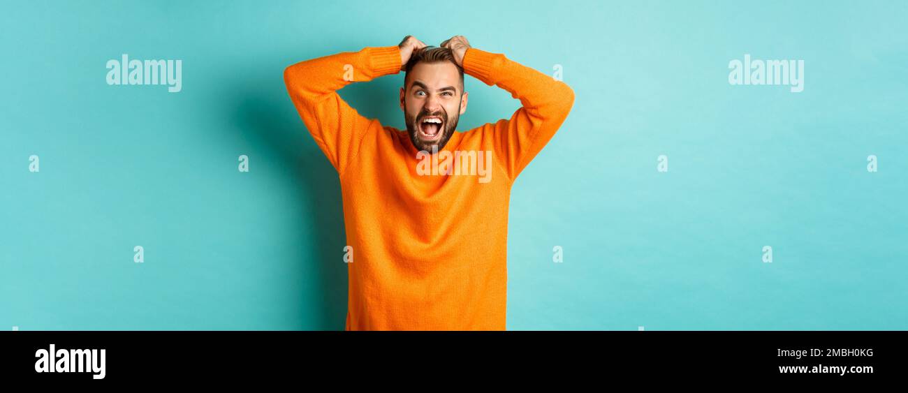 Frustrated man shouting, pulling out hair and screaming angry, losing ...