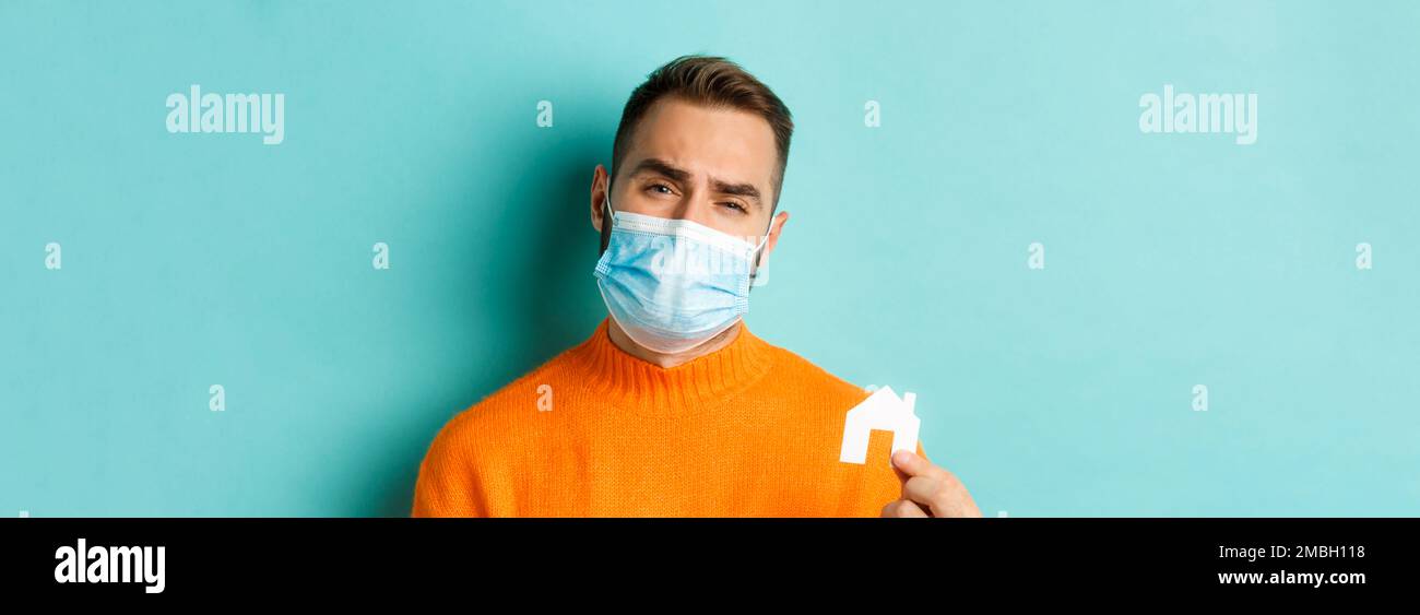 Real estate and coronavirus pandemic concept. Close-up of sad man in ...