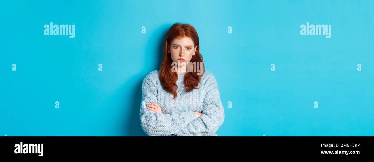 Annoyed and bothered redhead teeange girl cross arms on chest, staring ...