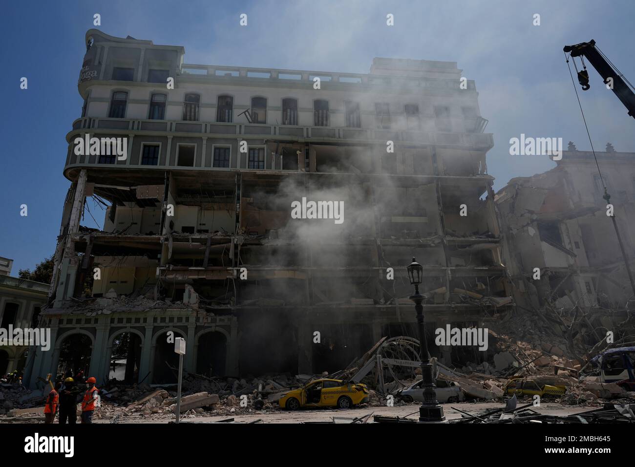 Smoke and dust linger at the five-star Hotel Saratoga after a deadly ...