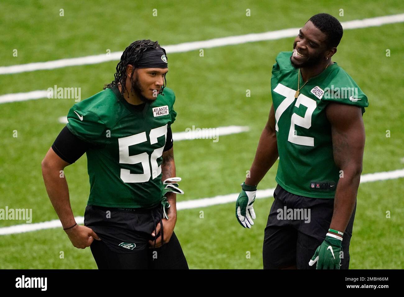 New York Jets' defensive linemen Jermaine Johnson (52) and Michael ...