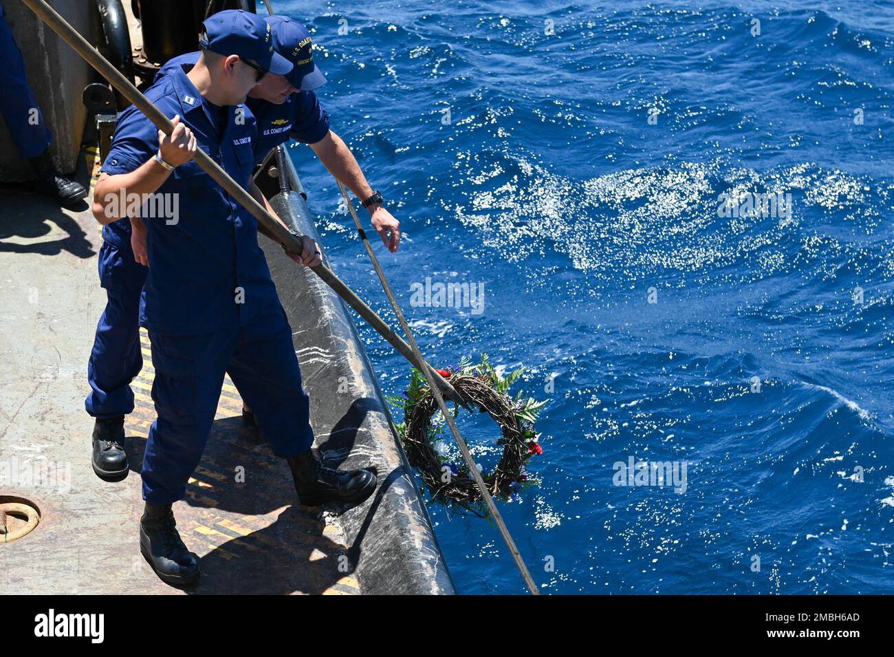 Crewmembers from Coast Guard Cutter Maple lay a wreath at the sight of ...