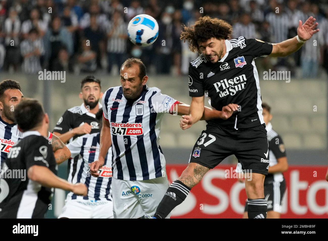 Hernan Barcos of Peru's Alianza Lima, left, and Maximiliano Falcon of ...