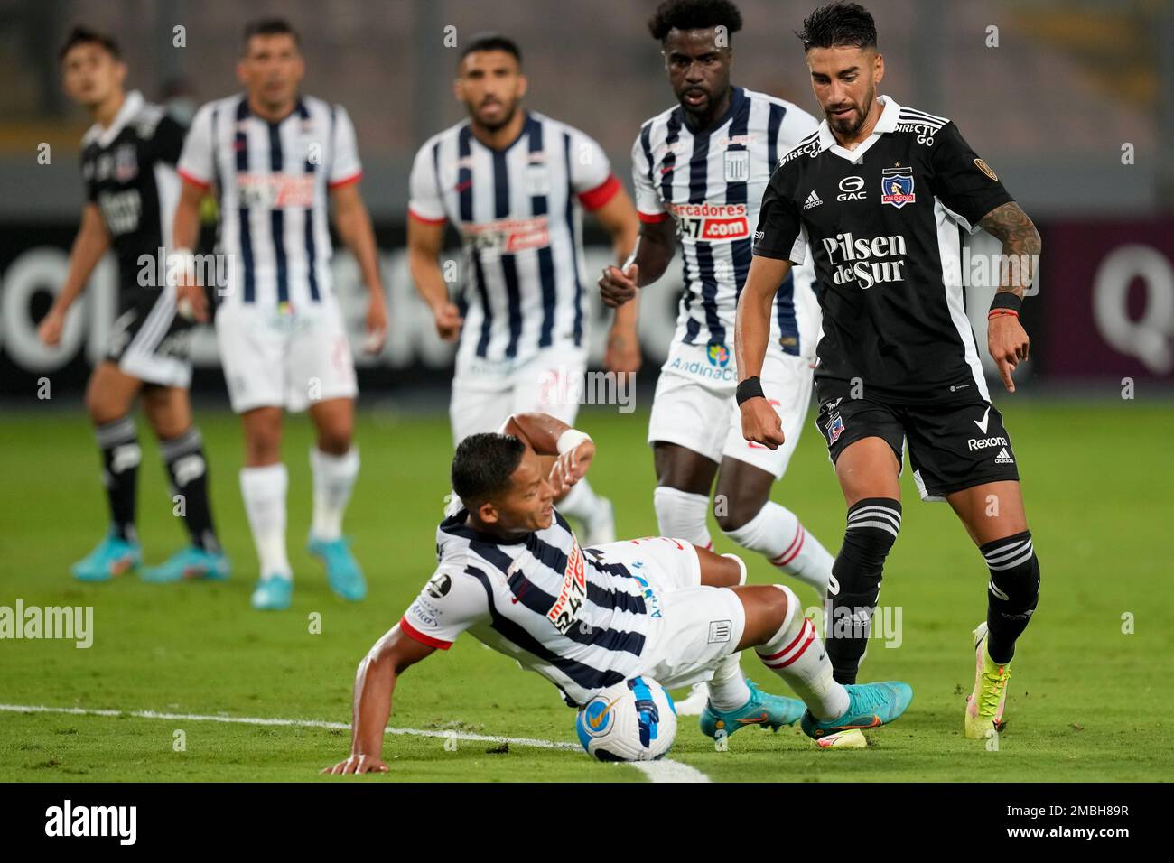 Juan Lucero of Chile's Colo Colo, right, Yordi Vilchez of Peru's Alianza Lima battle for the ...
