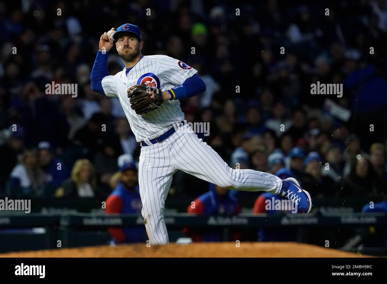 Chicago Cubs' Patrick Wisdom fields the ball and throws to first in a ...