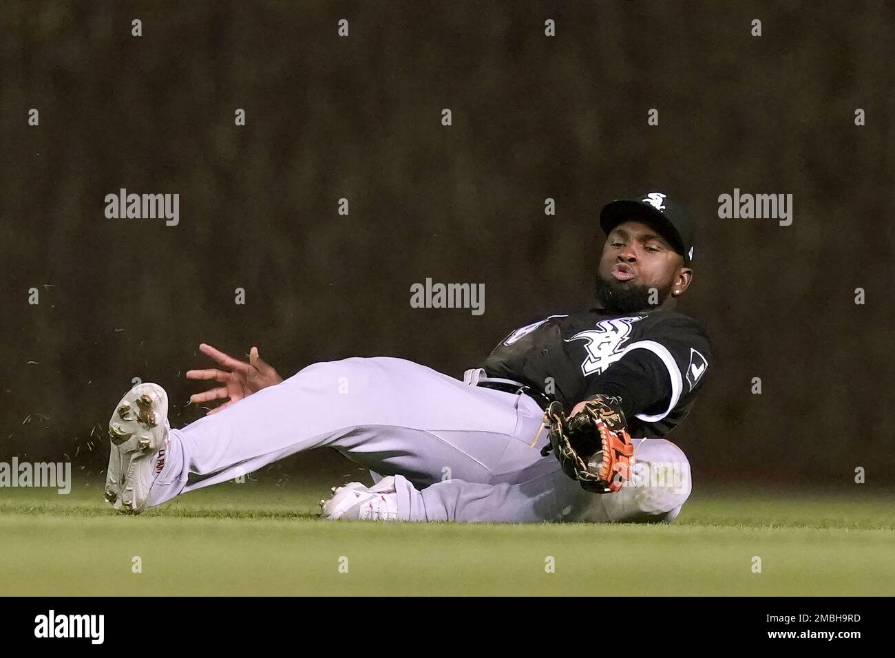Chicago White Sox's Luis Robert gloves a shot hop off the turf in a ...