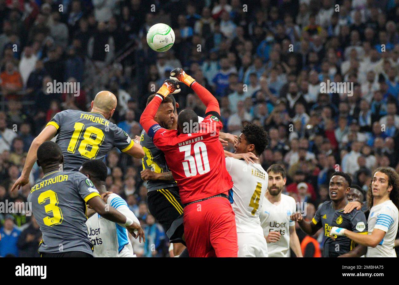 Marseille's goalkeeper Steve Mandanda, center, makes a save during the ...