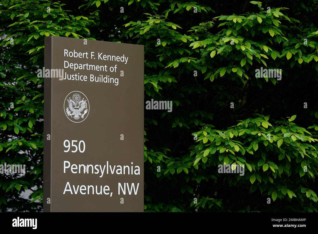 A sign stands outside the Robert F. Kennedy Department of Justice ...