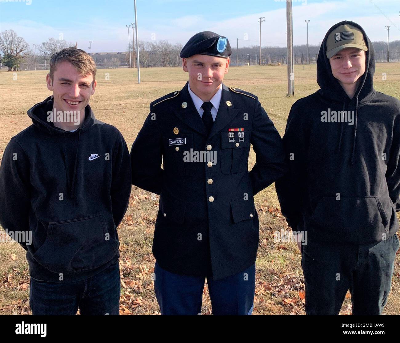 Specialist Tyler Zatezalo, center, is joined by his brothers Bryan ...