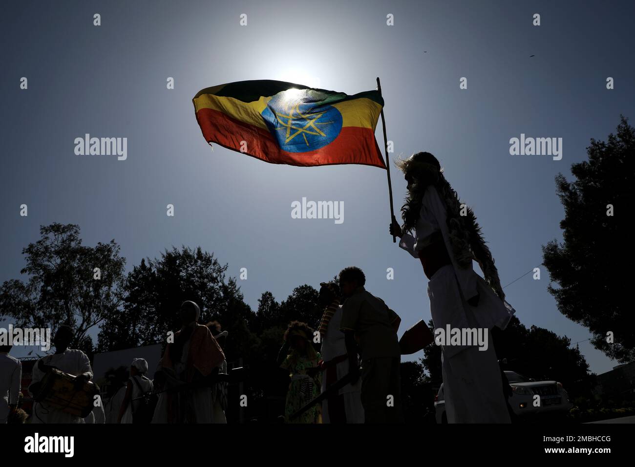A dancer holds a national flag as they perform at an event to ...