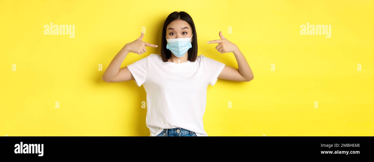 Covid-19, quarantine and social distancing concept. Young asian woman ...