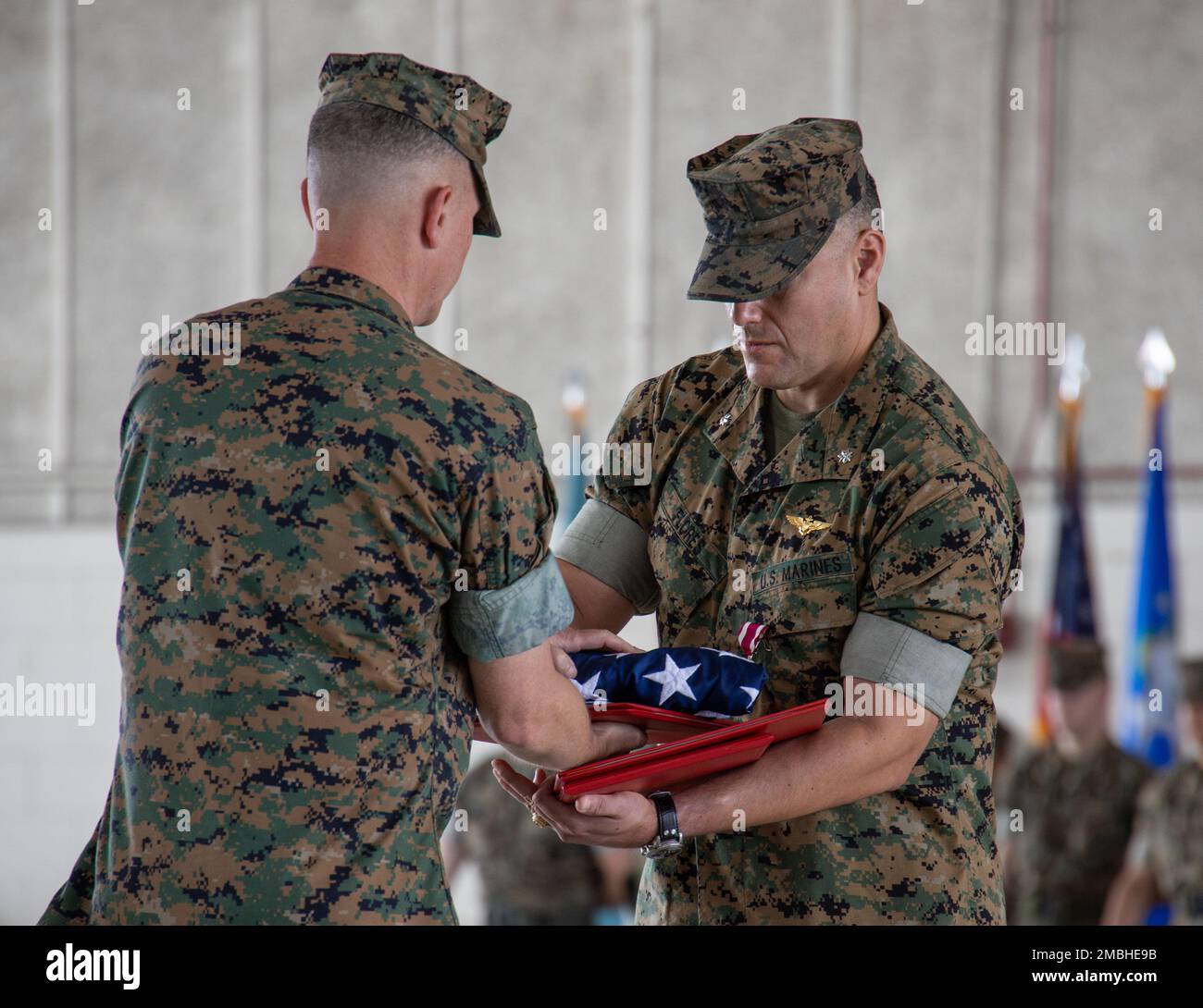 U.S. Marine Corps Lt. Col. Julian Flores is presented a folded American ...