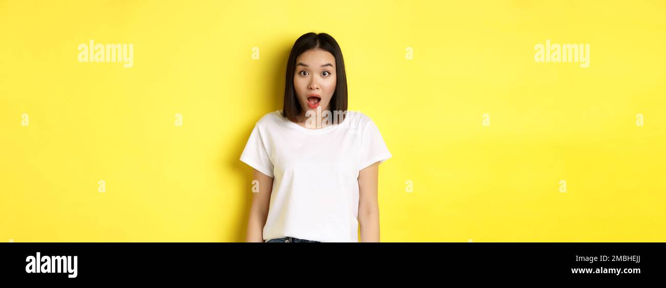 Beauty and fashion concept. Surprised asian girl open mouth and staring ...