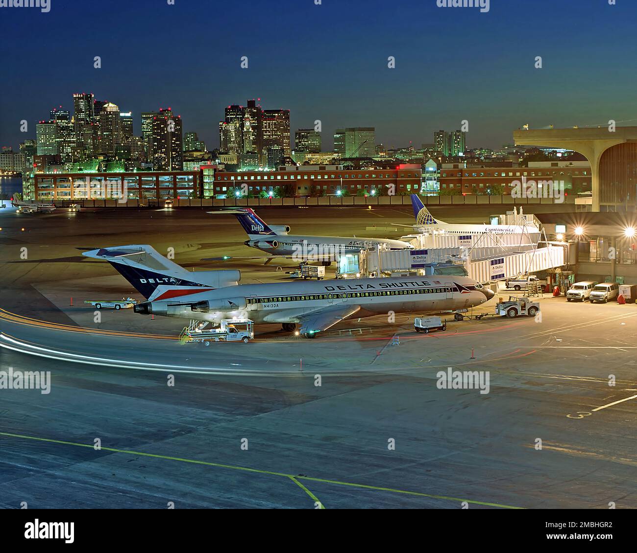 Delta Airlines Boeing 727 at terminal gate, twilight Boston city ...