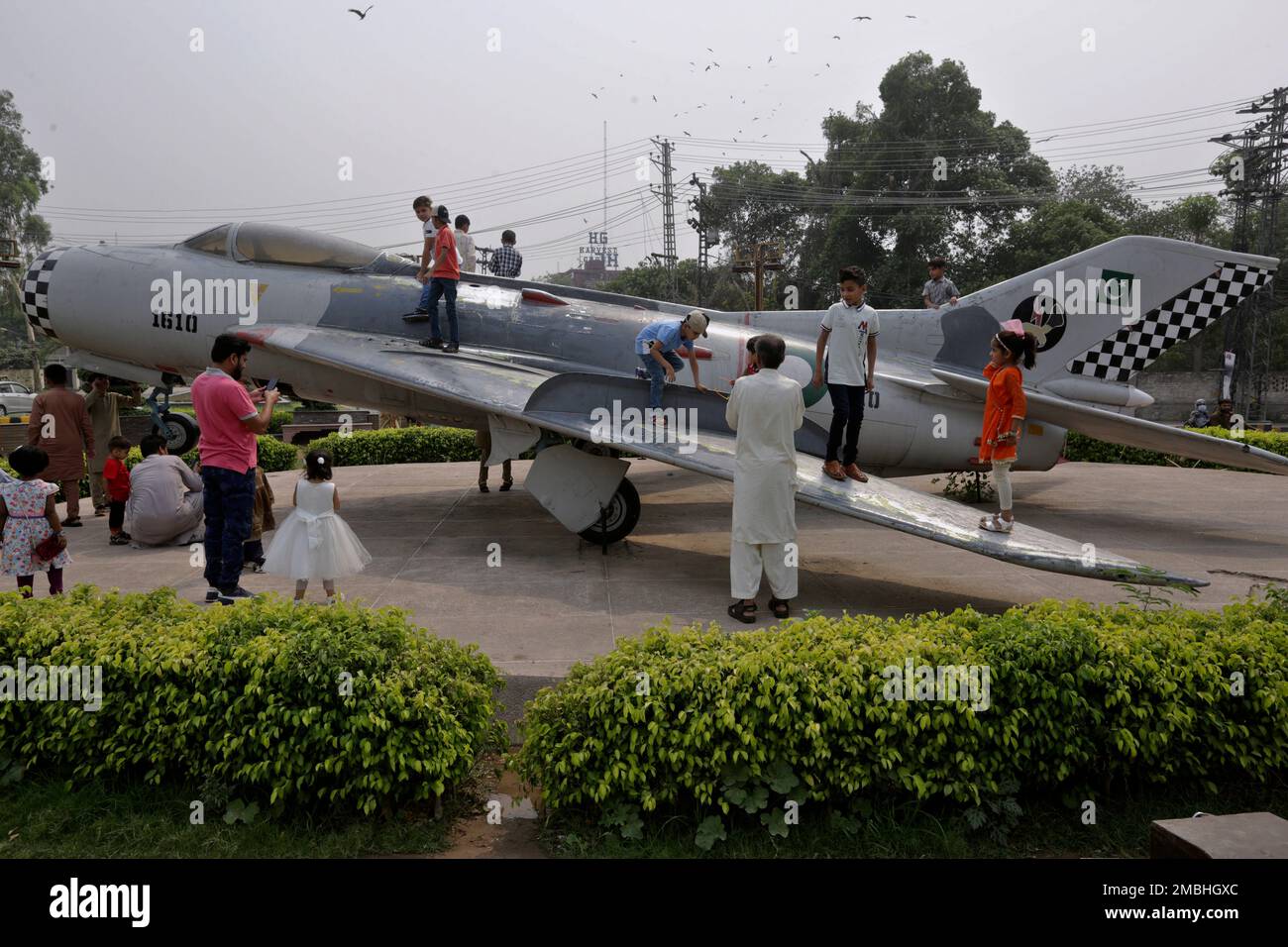 Children play on a model of fighter plane at a picnic point to ...