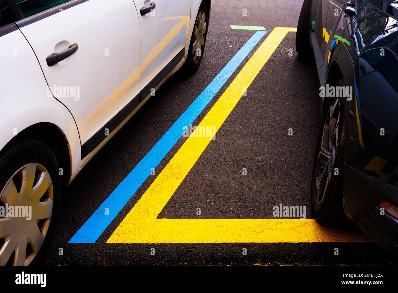 Blue and yellow lines to delimit paid car parks zone in lot Stock Photo ...