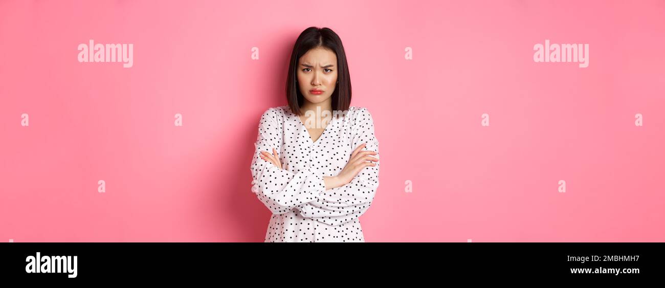 Timid and offended asian girl cross arms on chest, staring defensive ...