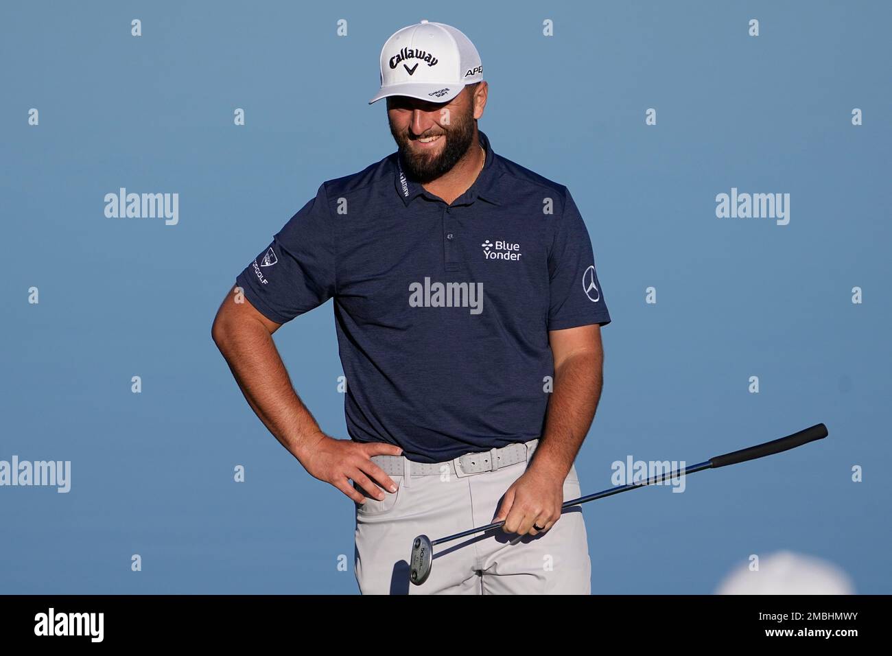 Jon Rahm smiles as he stands on the ninth green during the American ...