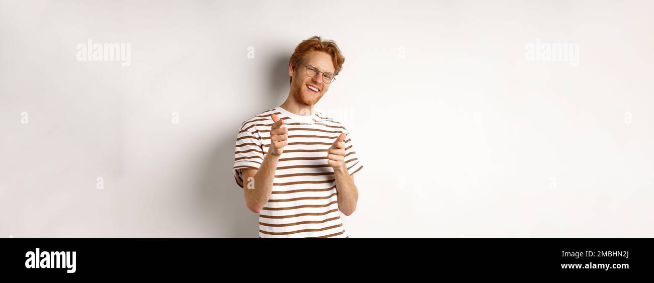 Cool And Sassy Redhead Man With Beard And Glasses Pointing Finger