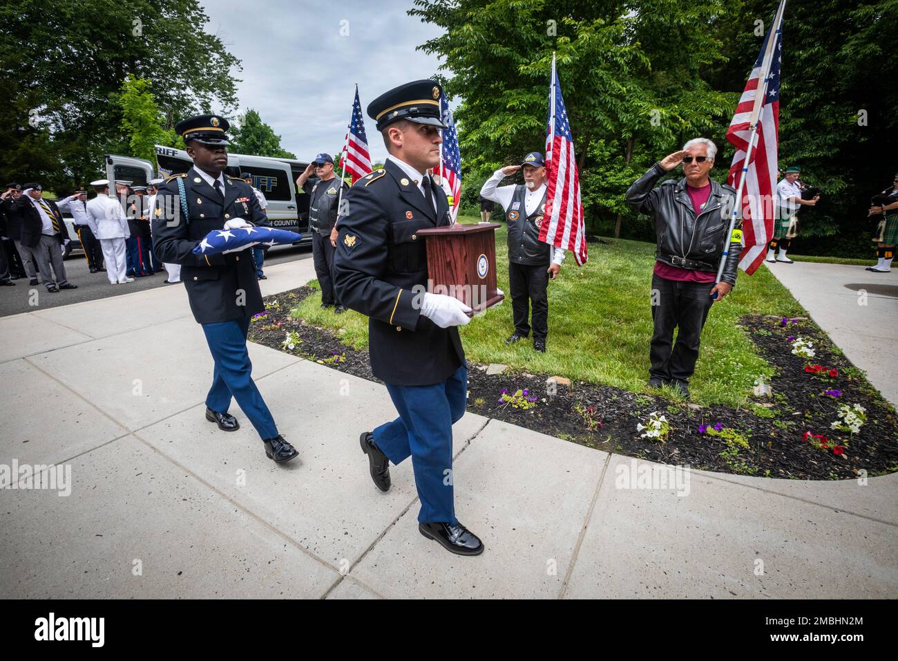 U.S. Army Spc. William J. Doyle, right, carries an urn containing a ...