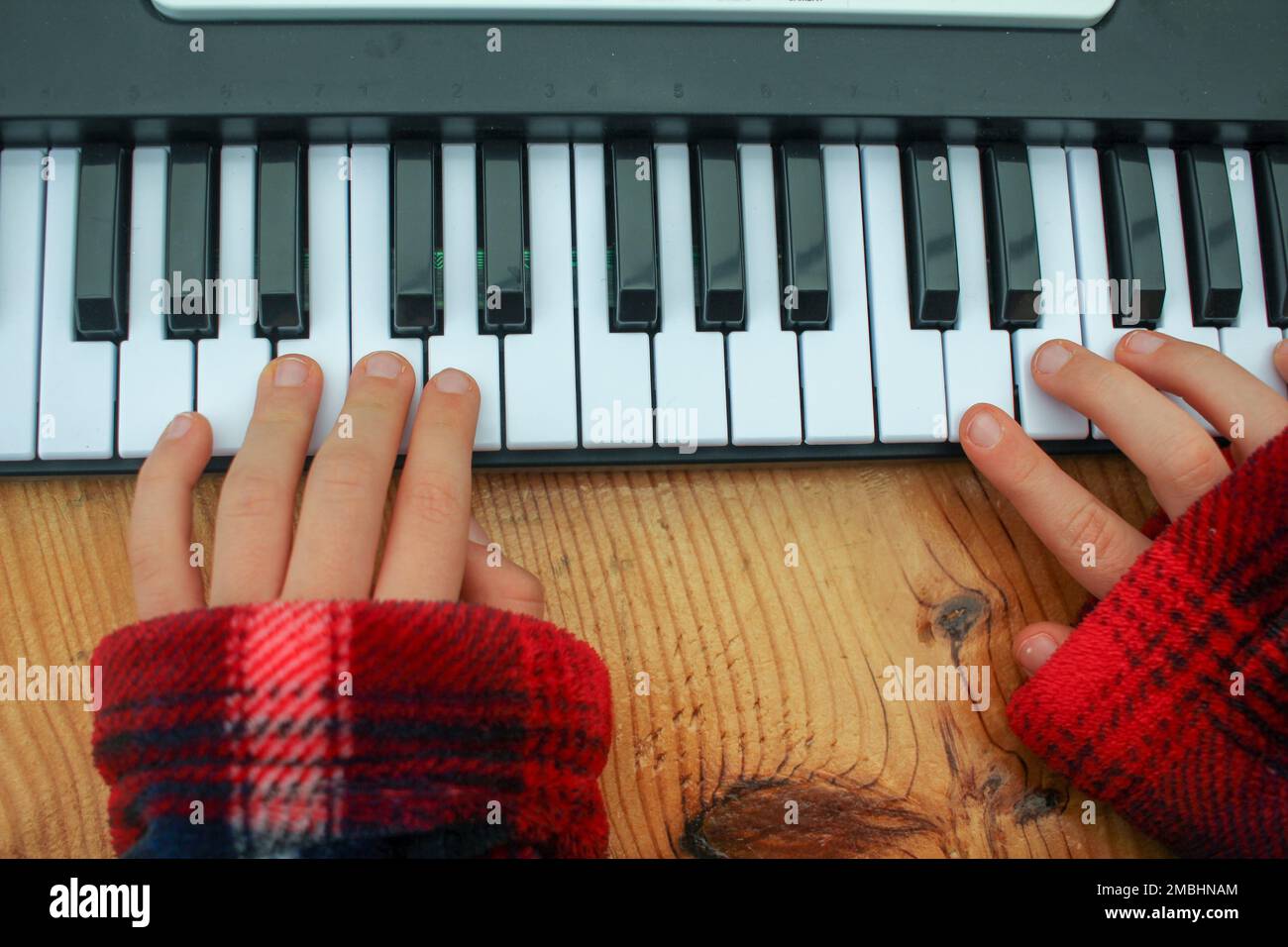 my son playing toy keyboard for fun Stock Photo - Alamy