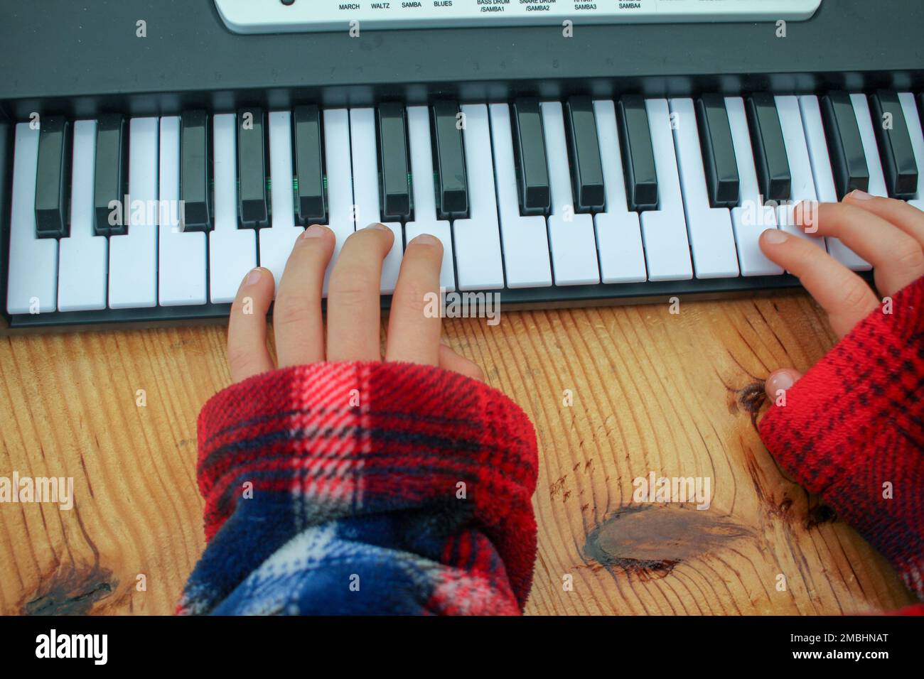 my son is happy playing keyboard at home Stock Photo - Alamy