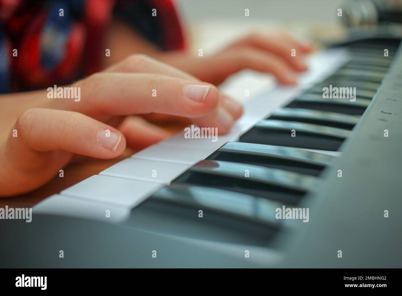 my son enjoys playing keyboard for fun Stock Photo - Alamy