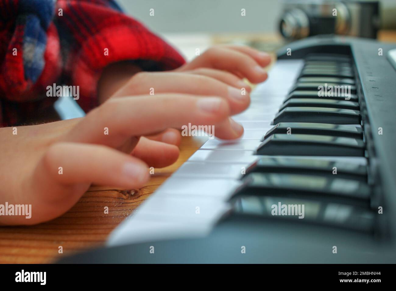 playing to piano keyboard at home during winter Stock Photo - Alamy