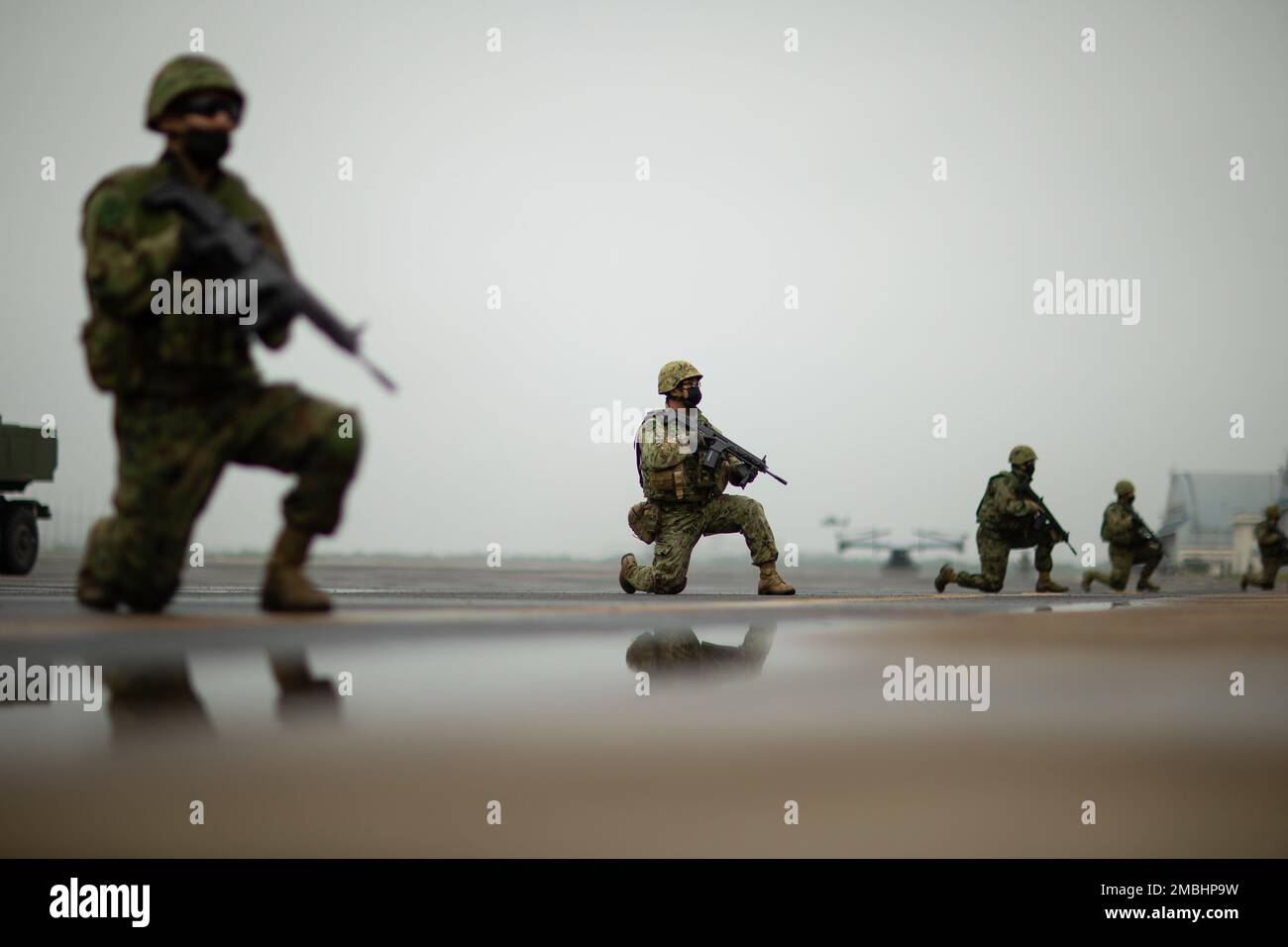 Soldiers with the Japan Ground Self-Defense Force secure an airfield as ...